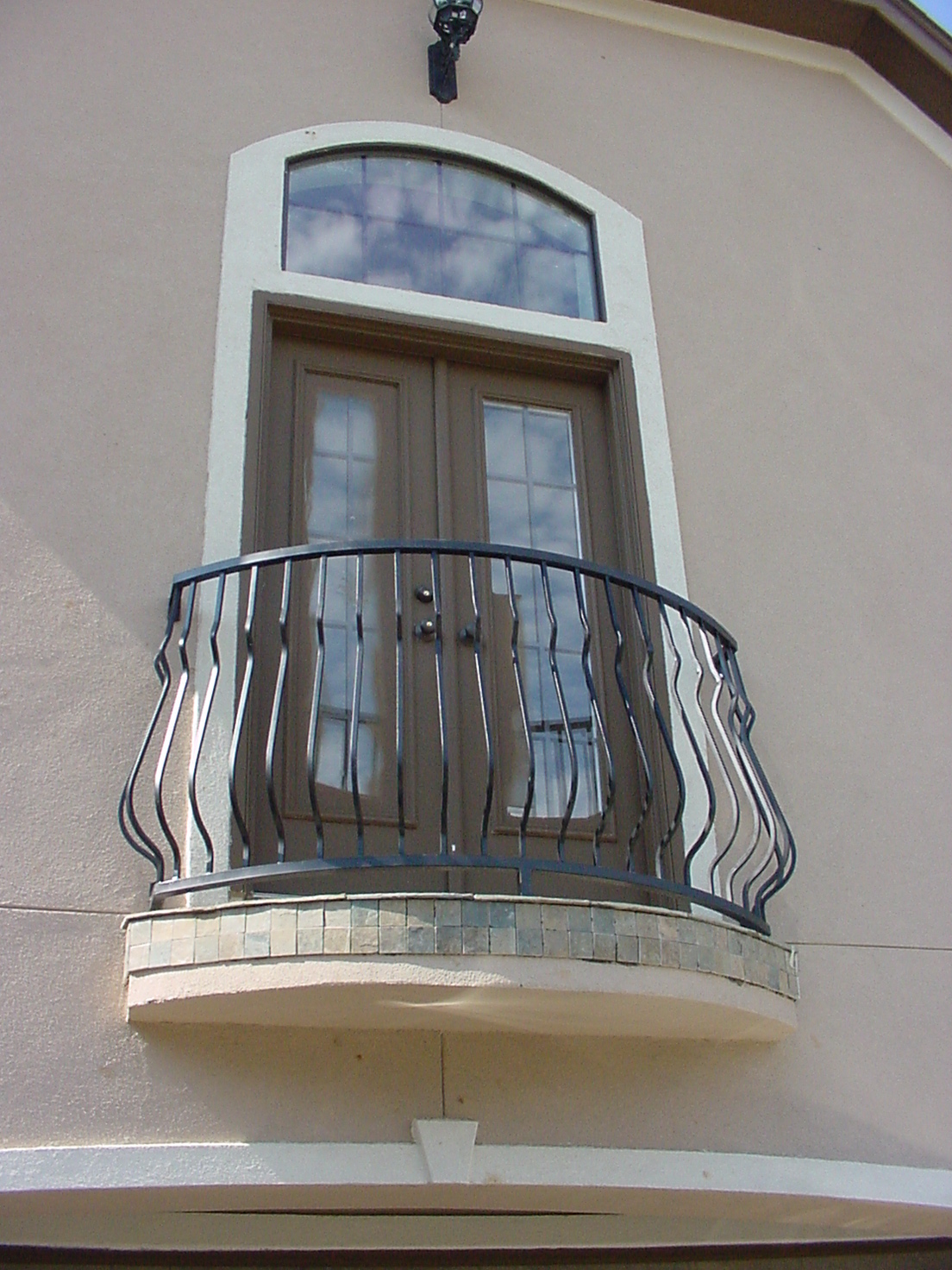 custom curved iron balcony | House of Forgings | Stair and Railing Products
